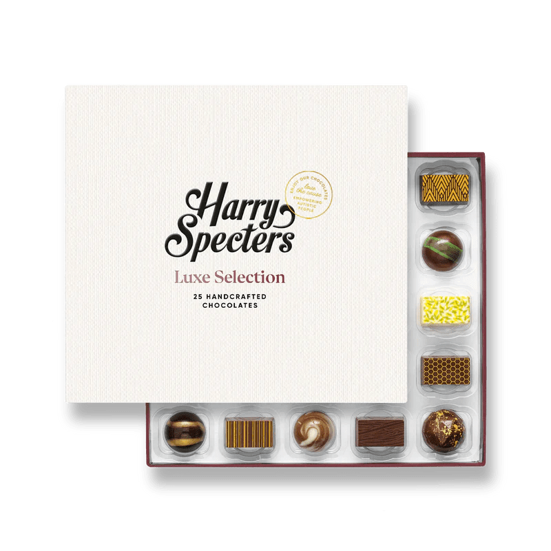 A box of 25 artisan chocolates partially covered by a box lid featuring ...